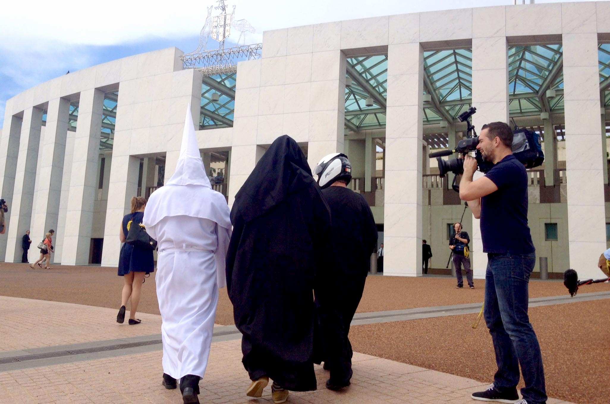 Men wearing KKK outfit, niqab and motorbike helmet try to enter ...