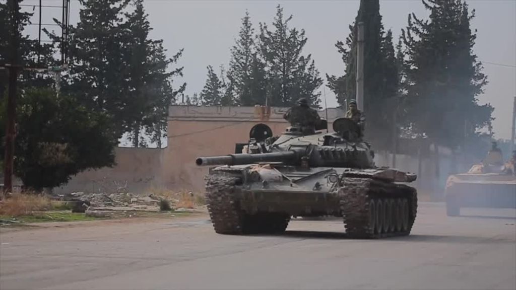Rebels drive military vehicles in Syria's Aleppo province as violence ...