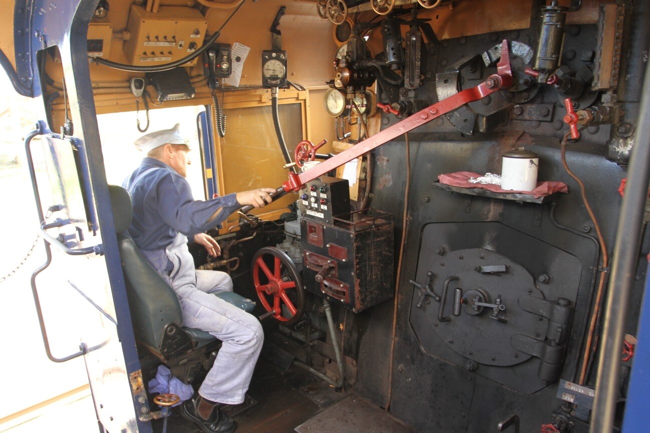 V-Line train driver behind locomotive-shaped hedges at Melbourne's ...