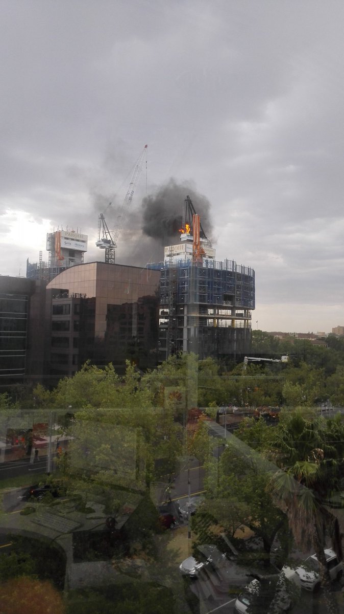 Crane collapses after catching fire at construction site on St Kilda ...