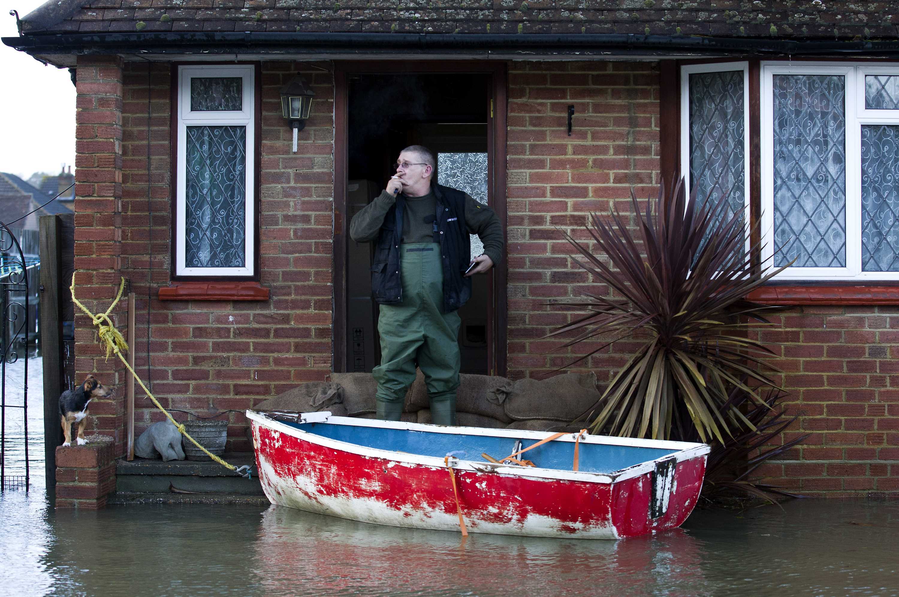 UK floods: One dead, 100,000 without power as storms batter flooded ...