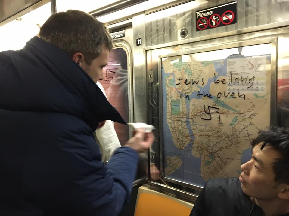 New York subway commuters band together to remove swastika graffiti ...
