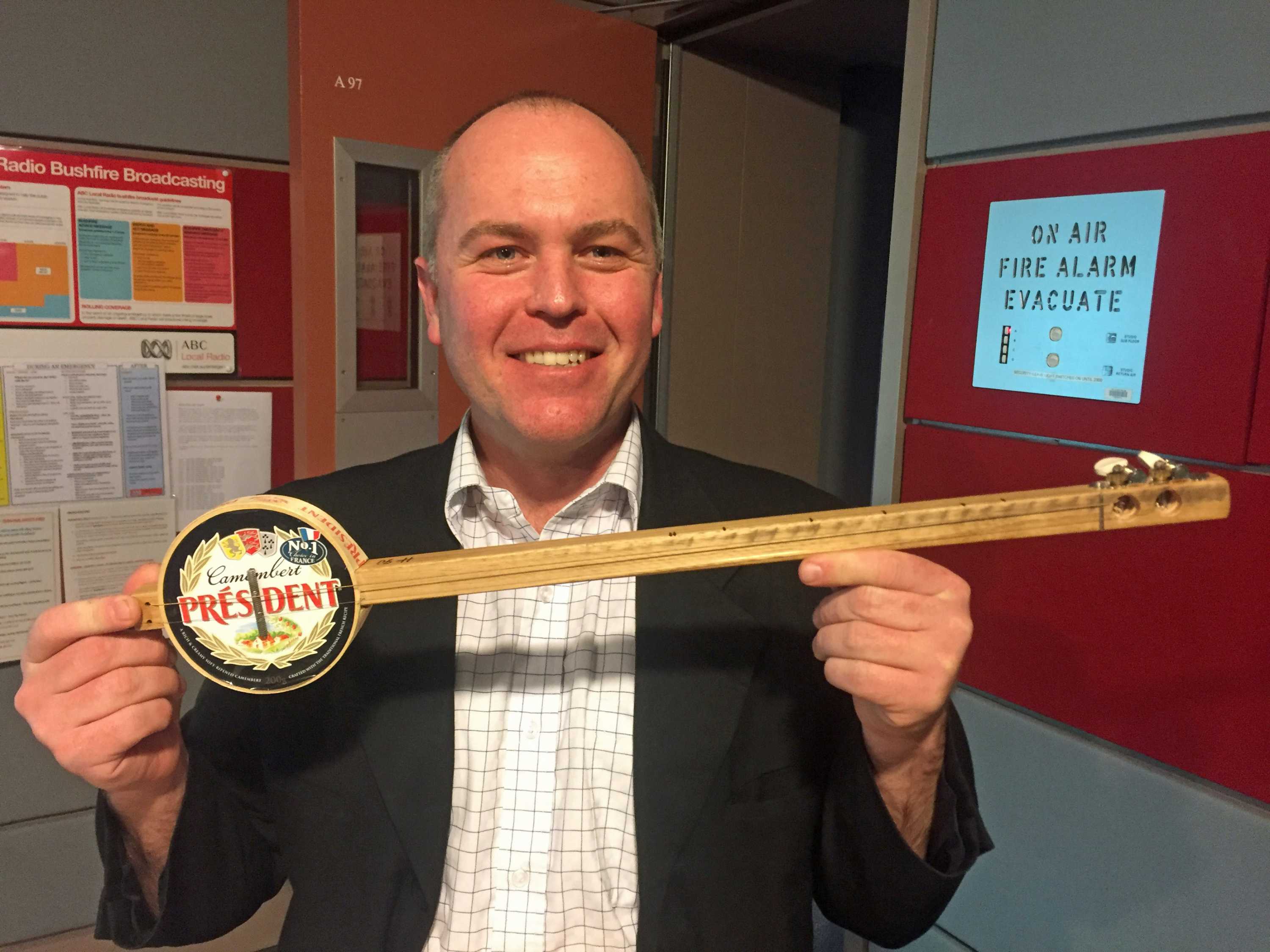 Hobart man crafting stringed instruments from recycled cigar and cheese ...