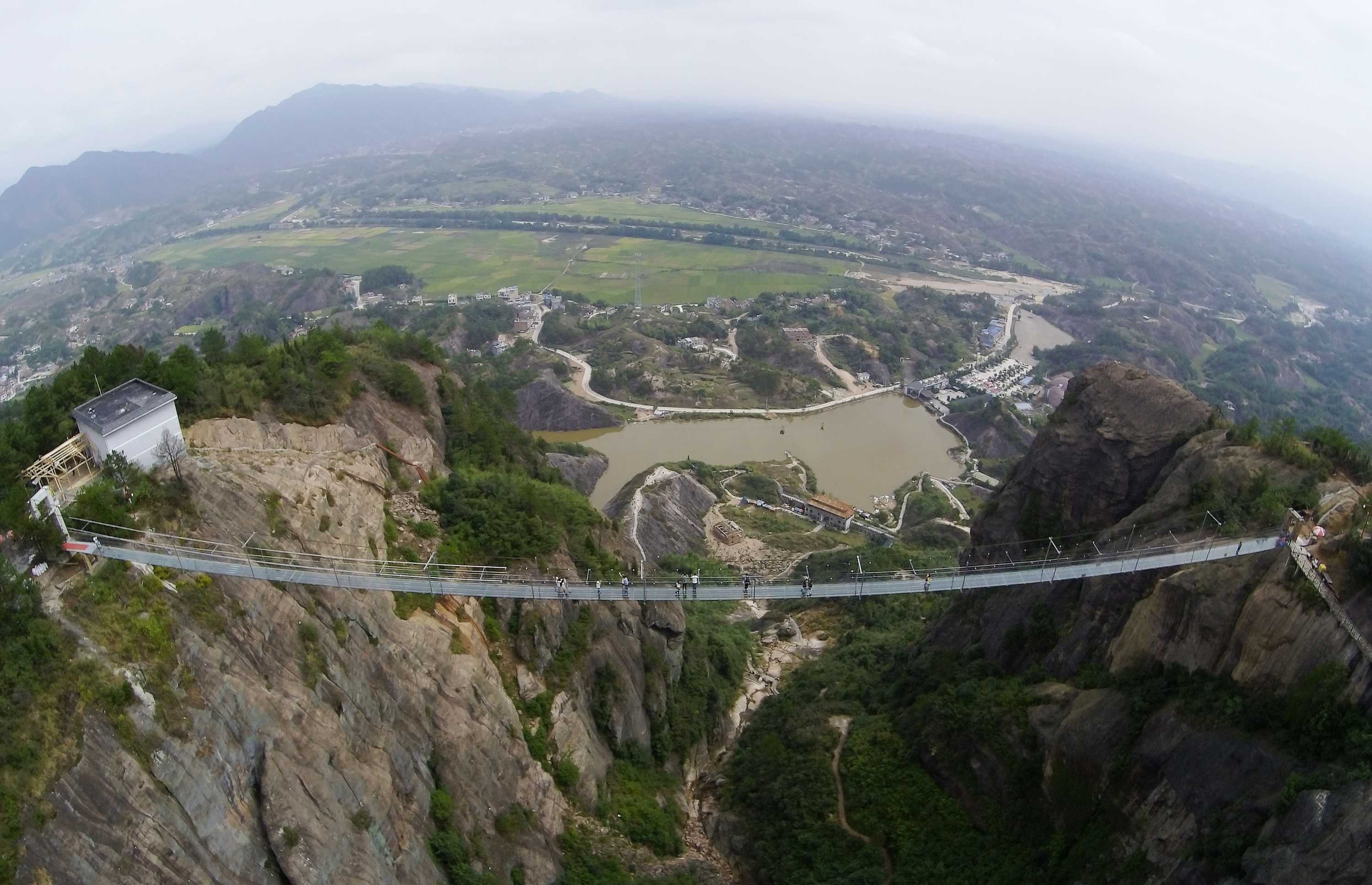 China opens glass suspension bridge in national park tempting tourists ...