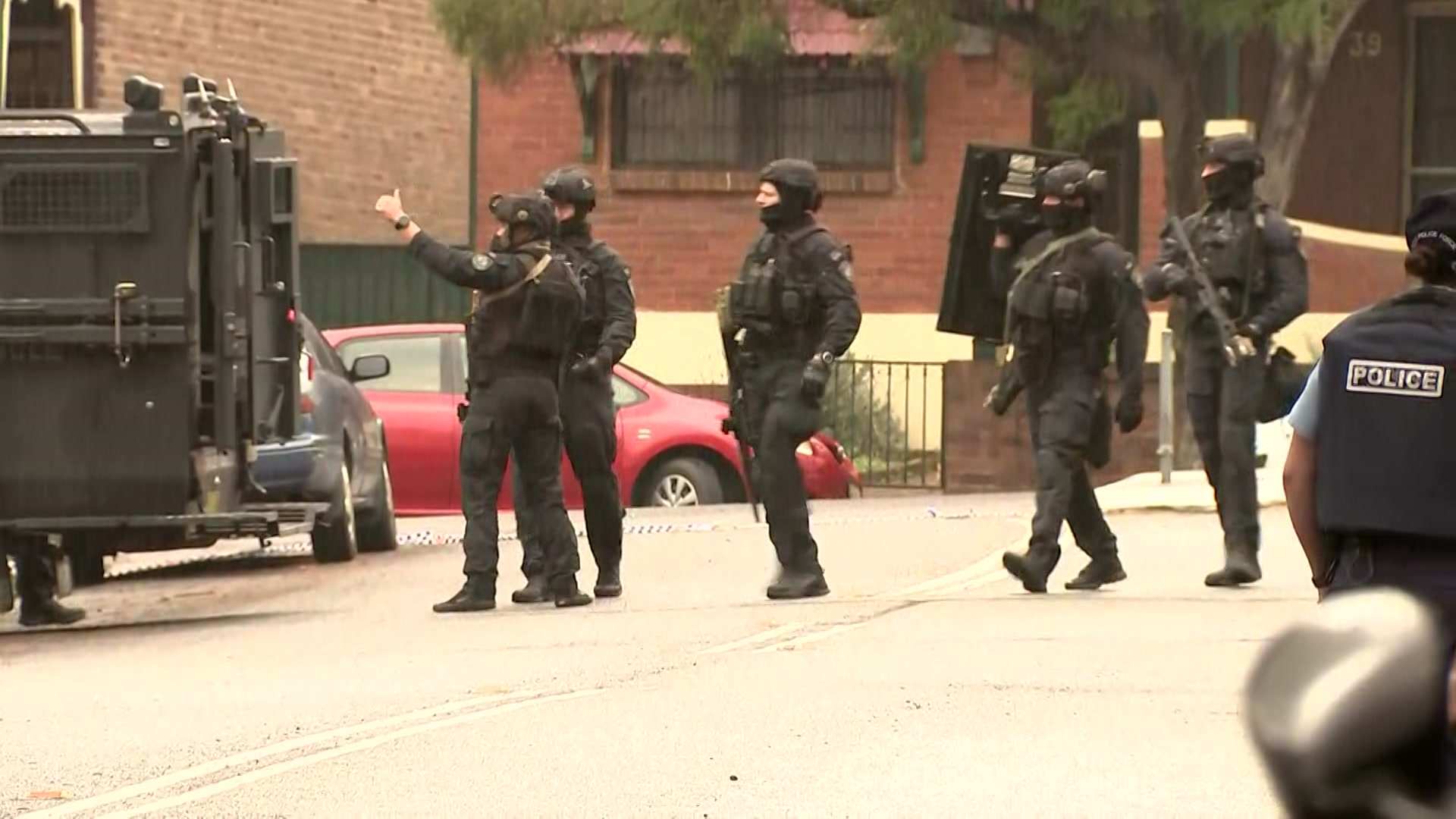 NSW Police riot squad officers swarm street in Sydney's inner west ...