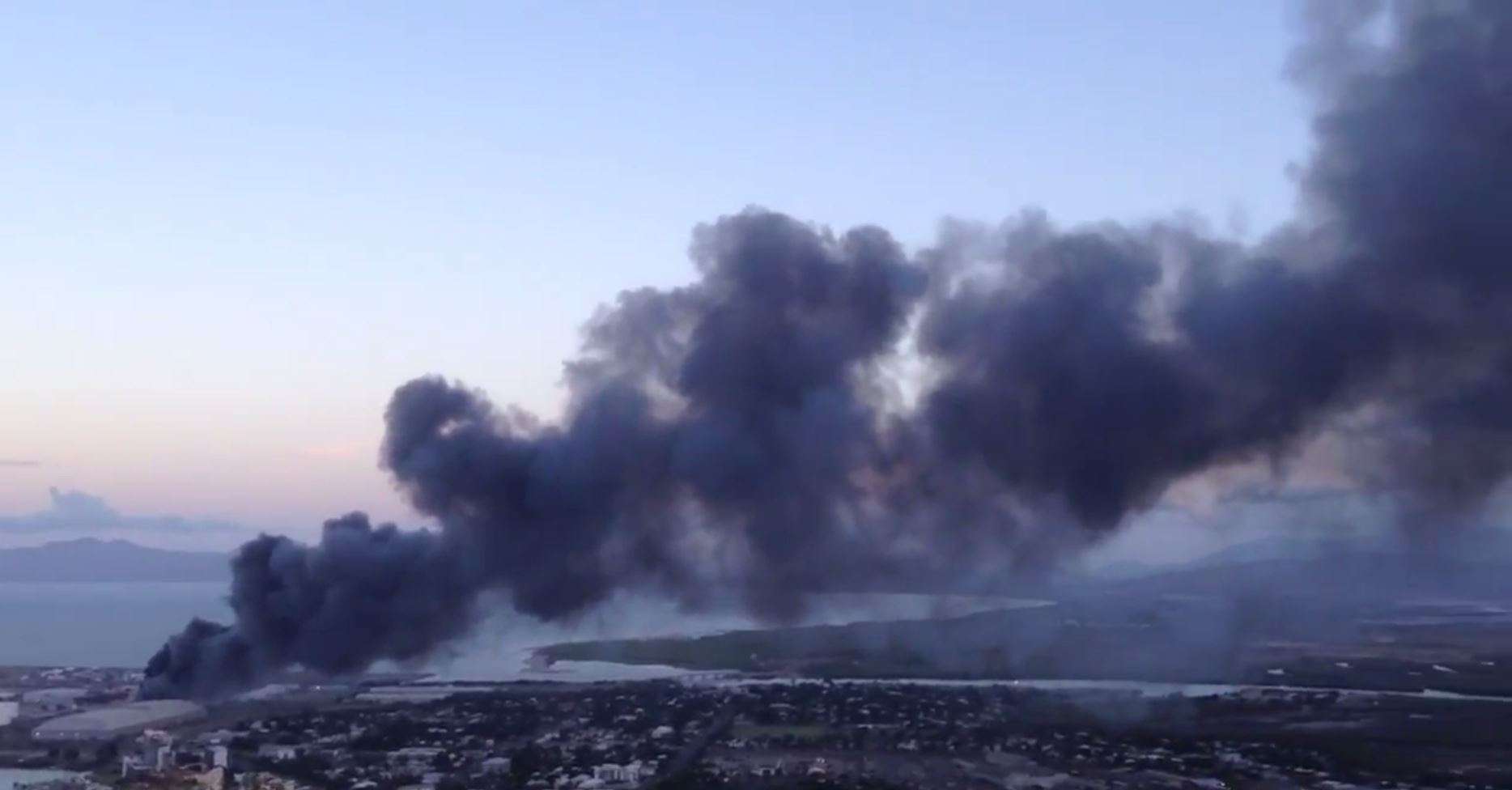 Scrap metal and plastic rubbish fire sends black smoke over Townsville ...