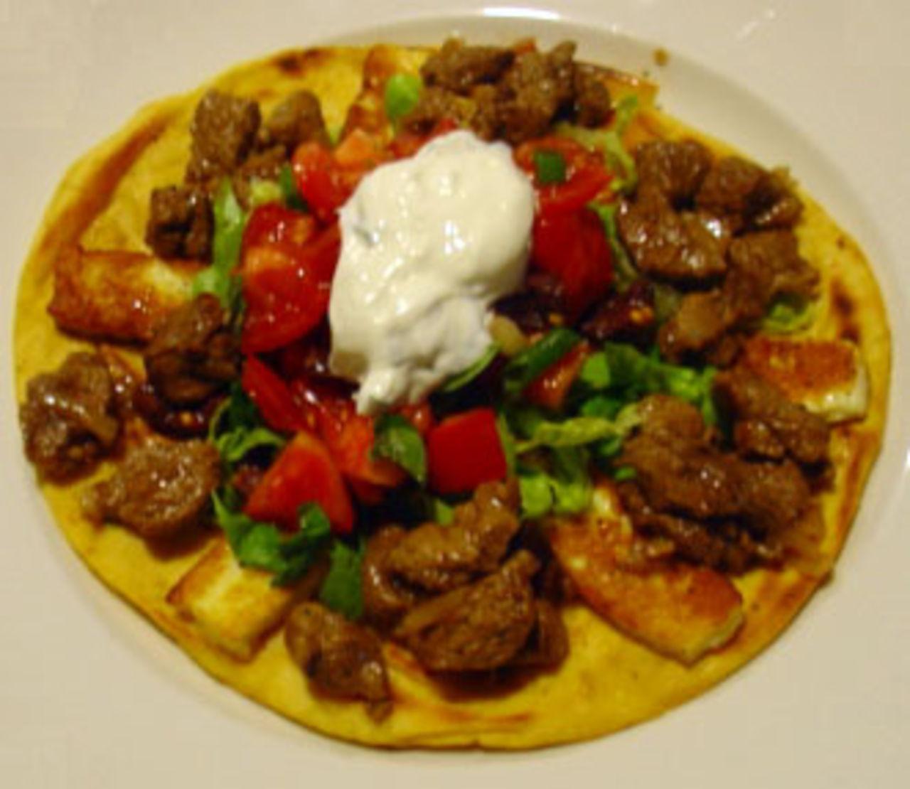 Lamb souvlaki with grilled Halloumi cheese and a Greek style salad ...