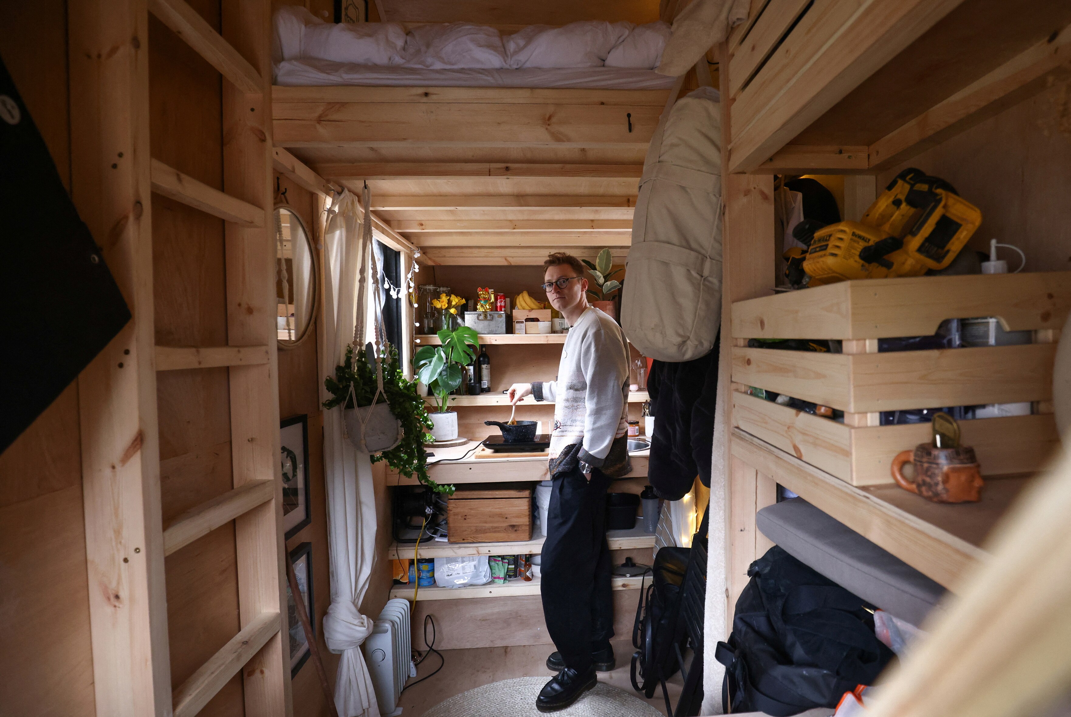 Artist builds home in a rubbish skip to protest against soaring rental ...