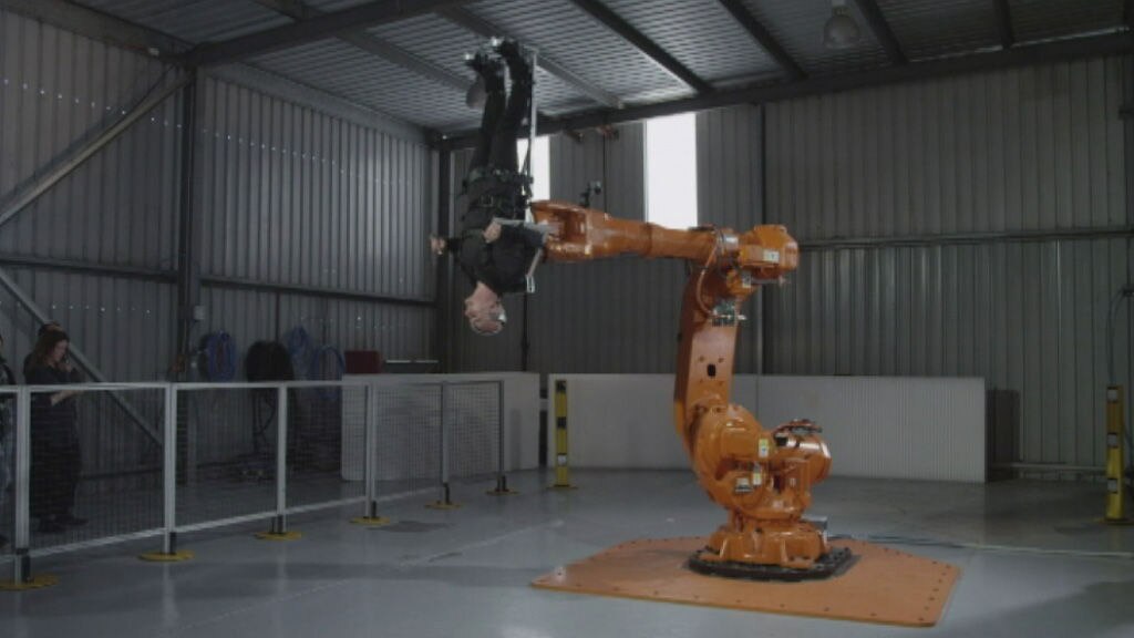 Stelarc spun around by giant robotic arm to demonstrate link between ...