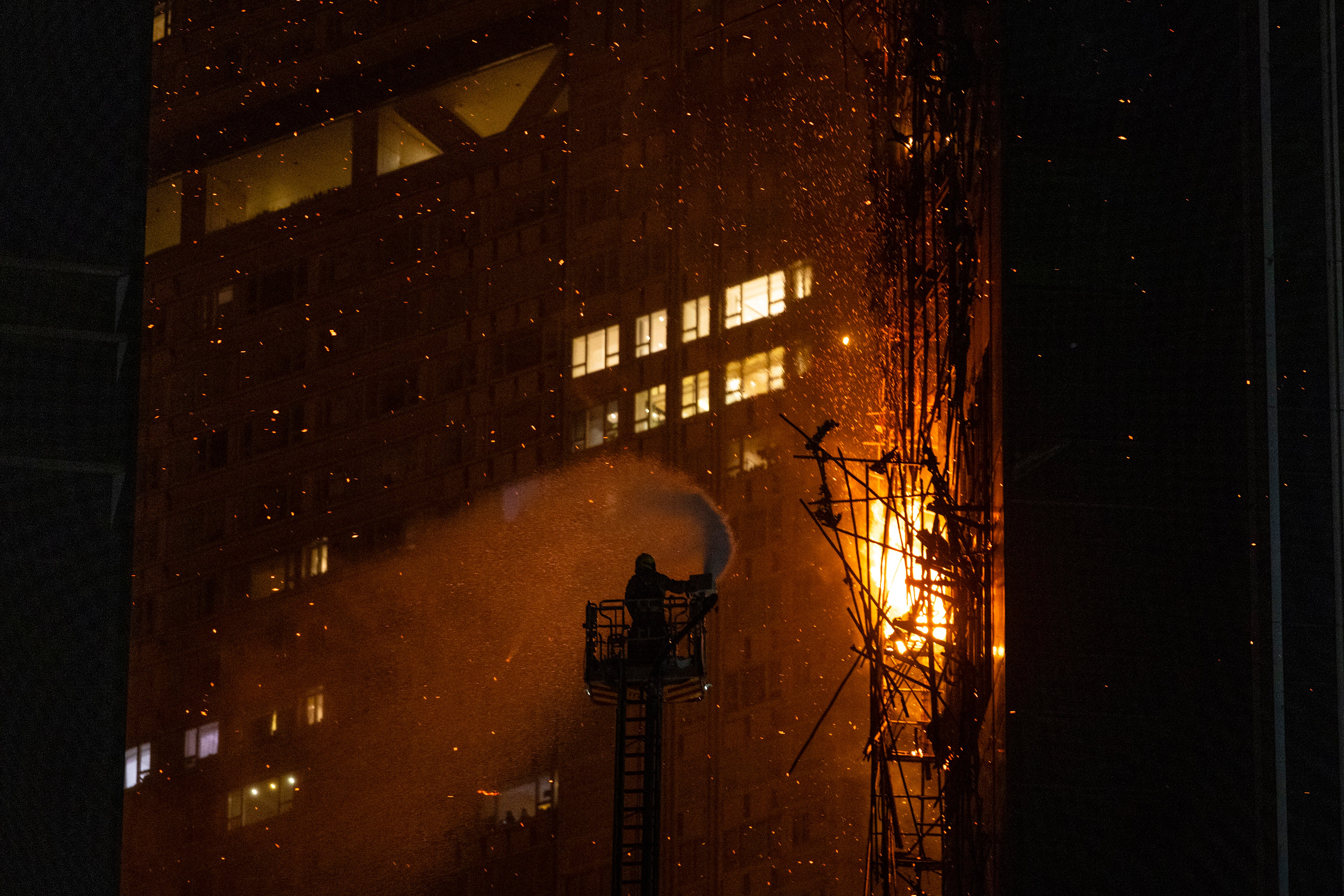 Firefighters battle high-rise blaze in Hong Kong's shopping district ...