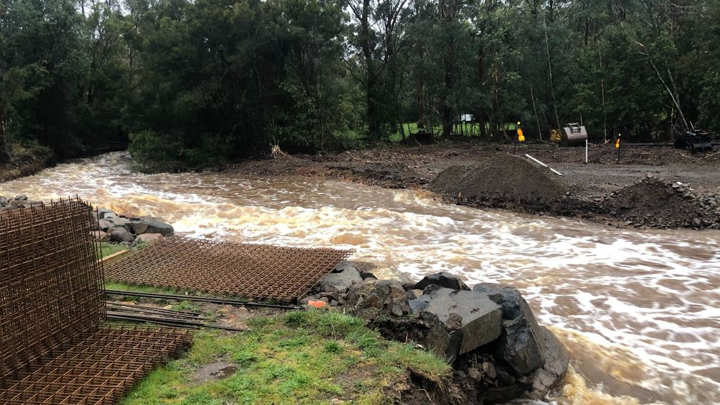 Rain washes out a bridge at Orford, on Tasmania's east coast. - ABC News