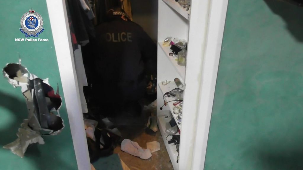 NSW Police allege the man was found hiding behind a hidden wall inside ...