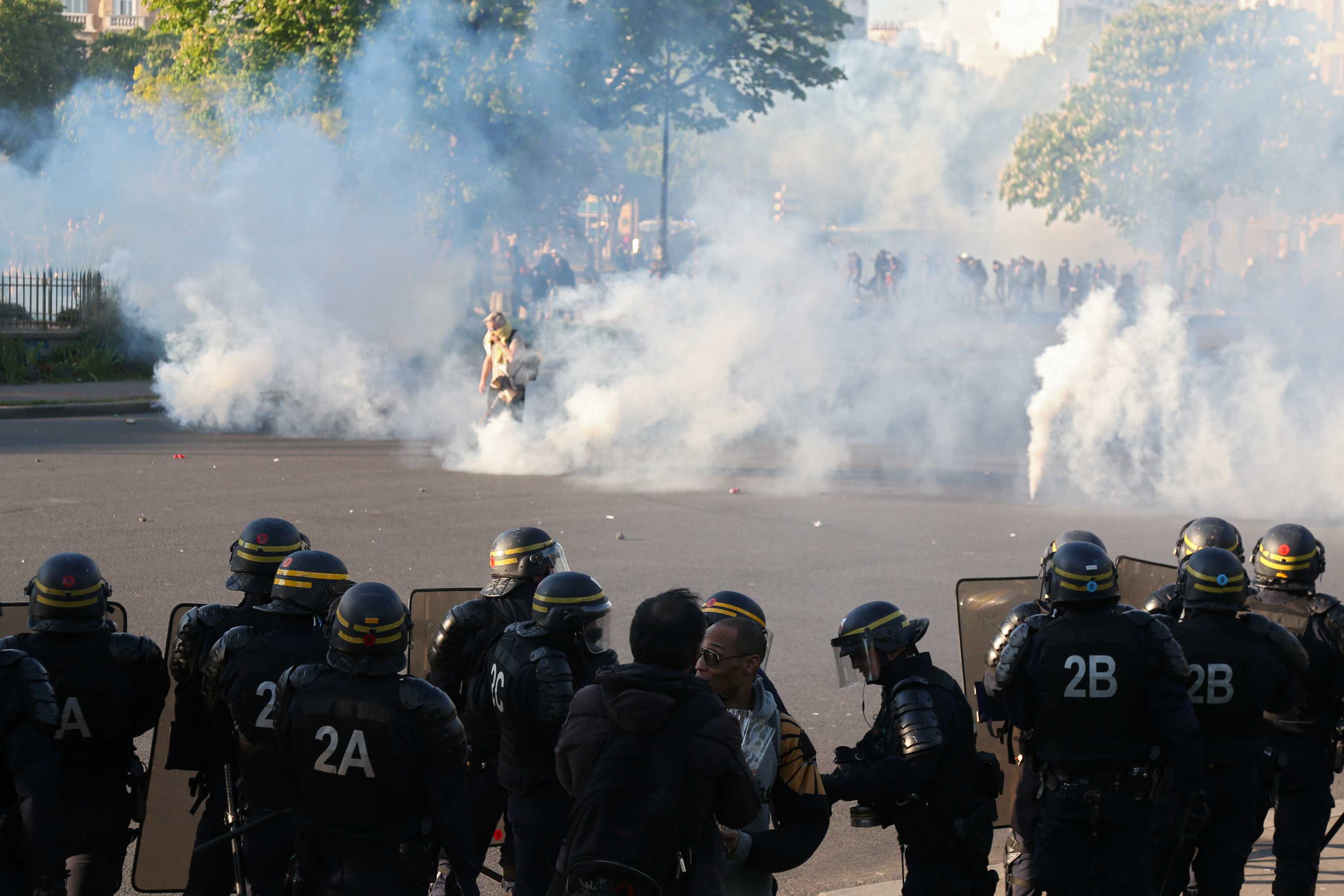 Hooded protesters clash with riot police in Paris over labour law ...