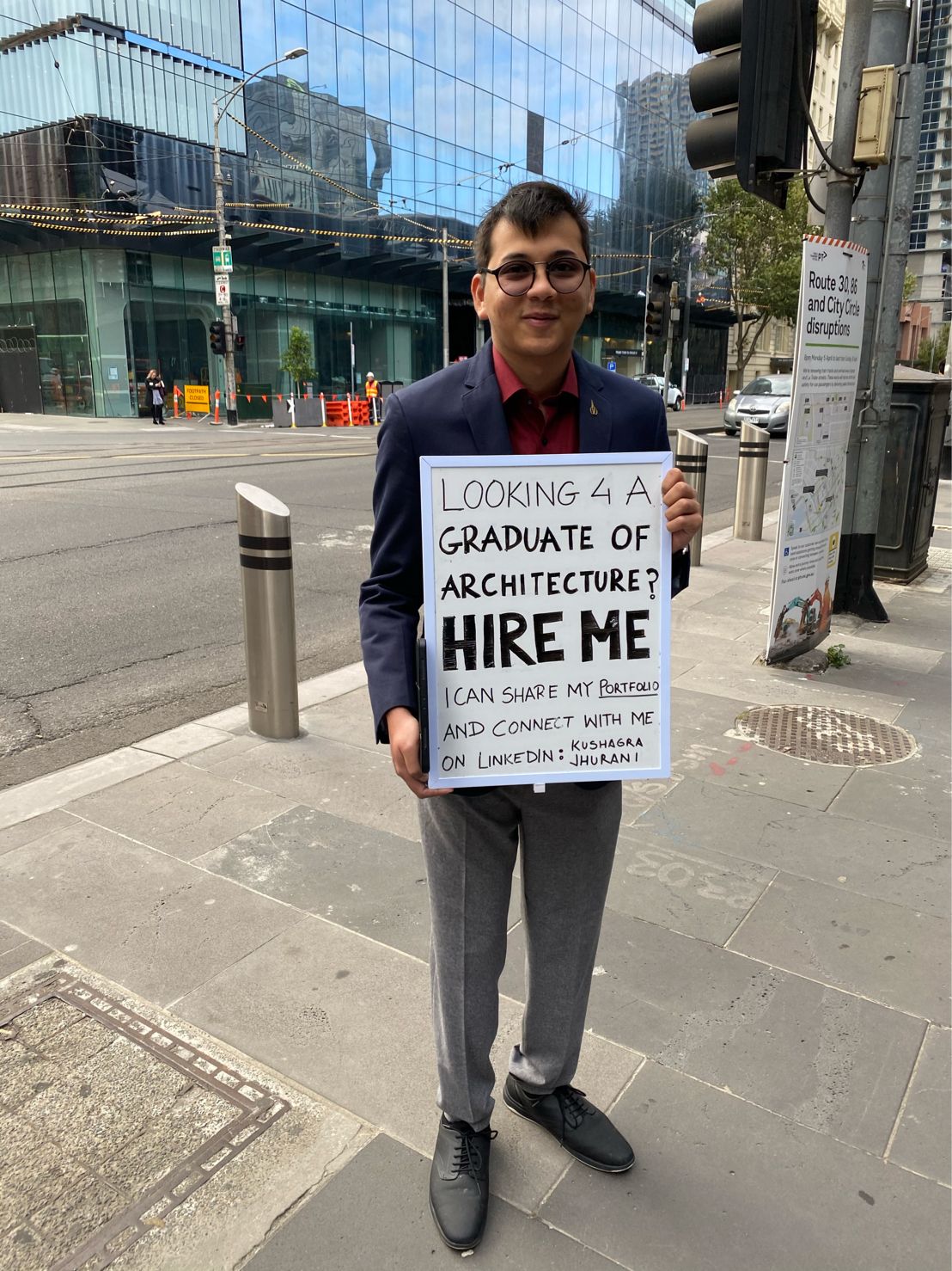 University graduate secures job by standing on Melbourne street with a ...