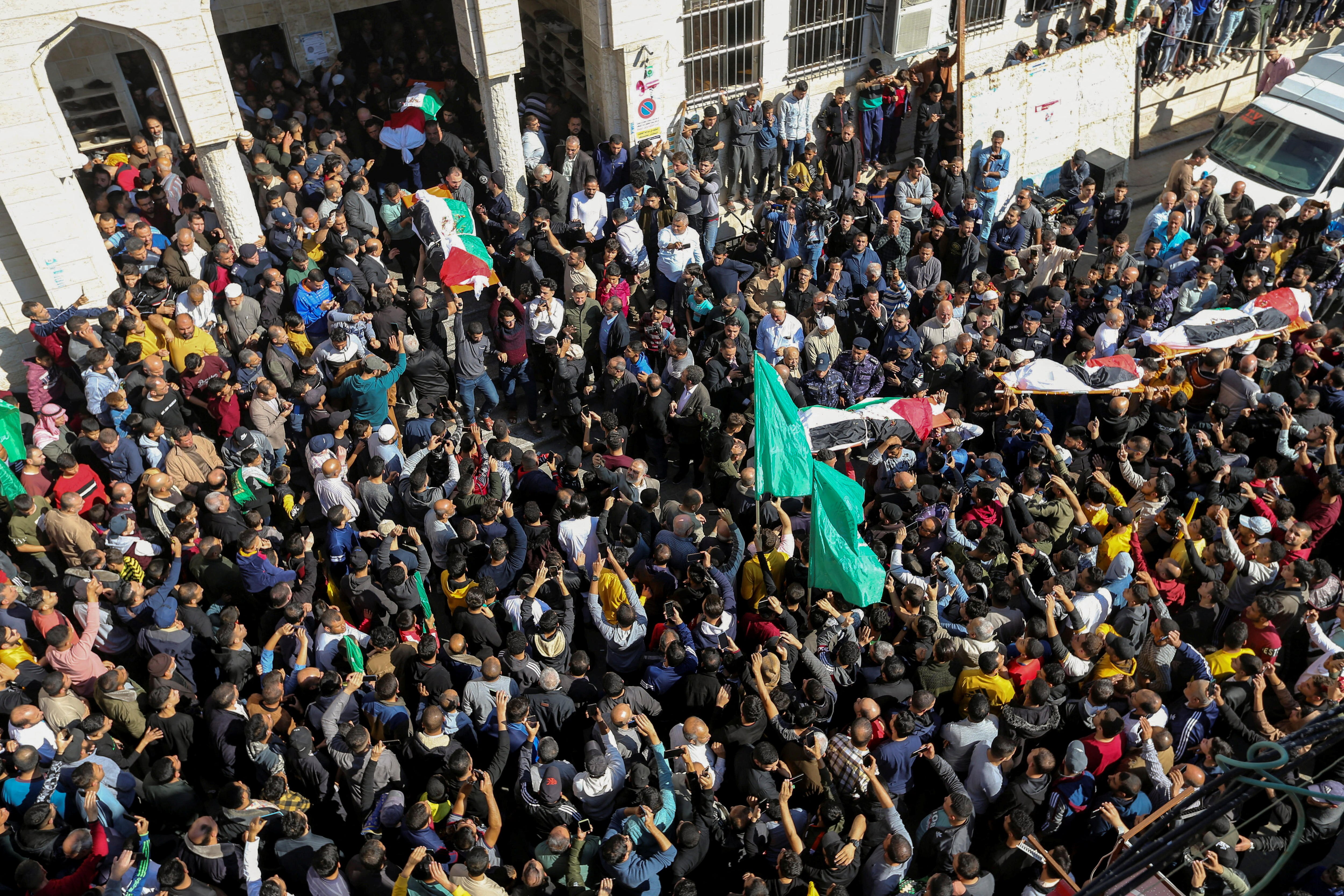 Palestinians flood streets of Gaza to mourn 21 people, including at ...