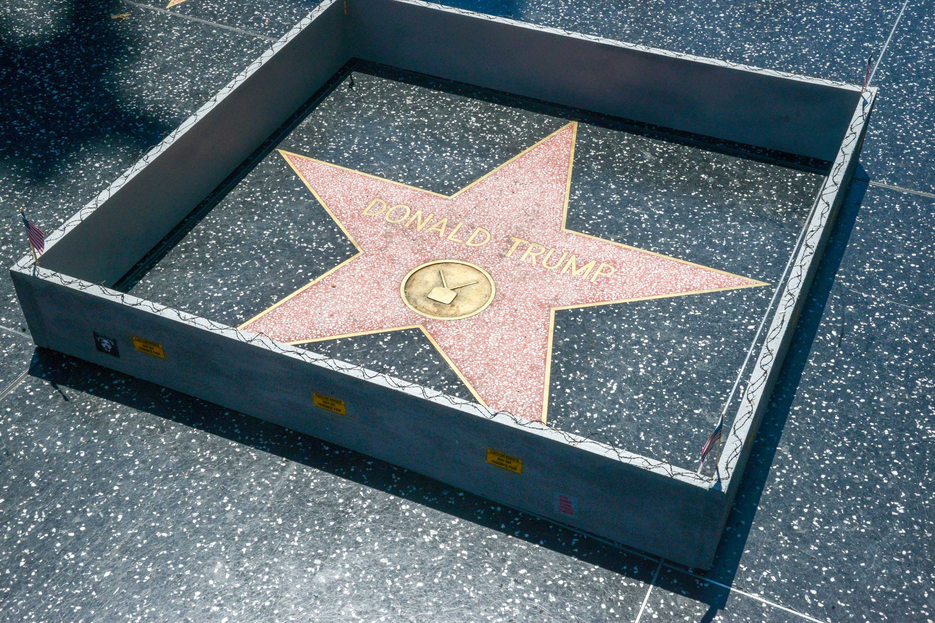 Donald Trump's Hollywood star adorned with tiny wall in street art ...