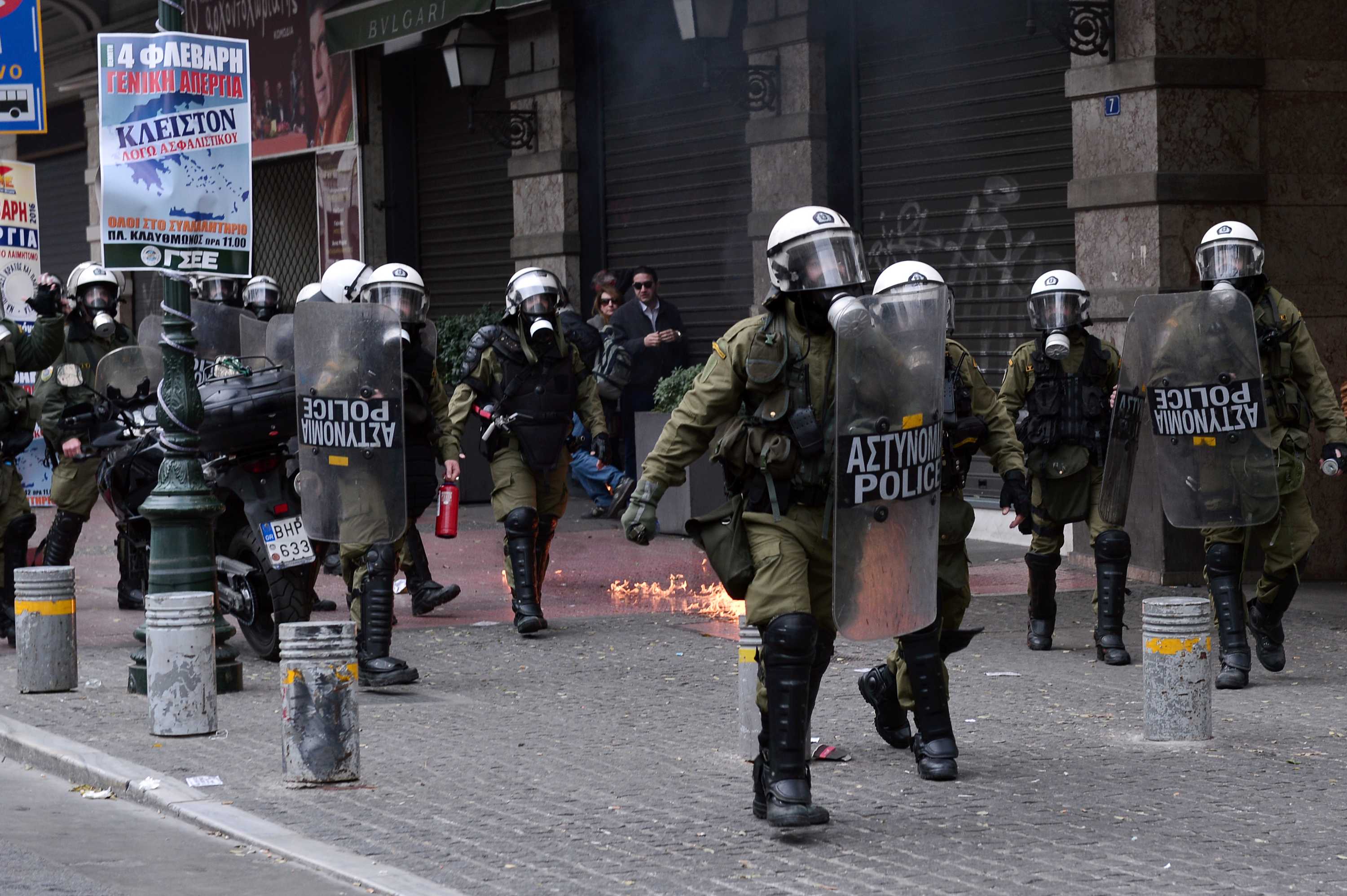 Greek riot police clash with protesters, fire tear gas over pension ...