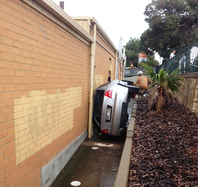 Two injured as car becomes wedged between Morphett Vale shop and ...