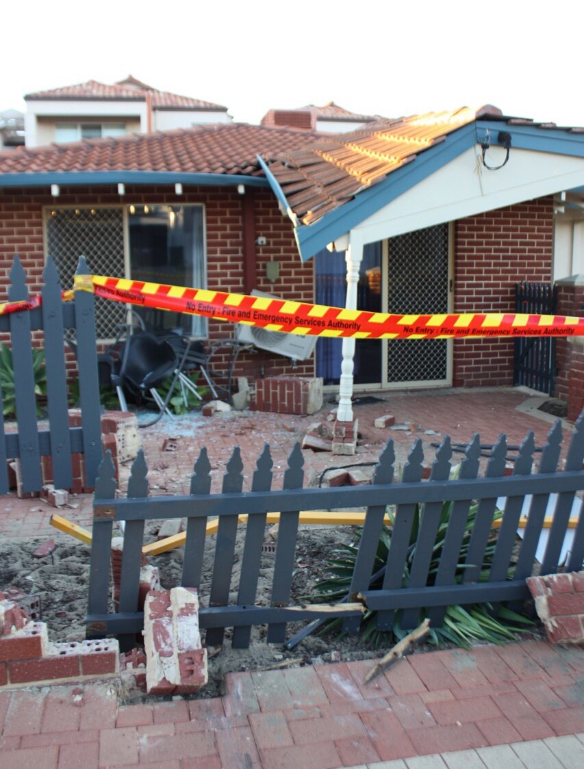 Man 'trying to evade police' crashes through fence into unit at ...