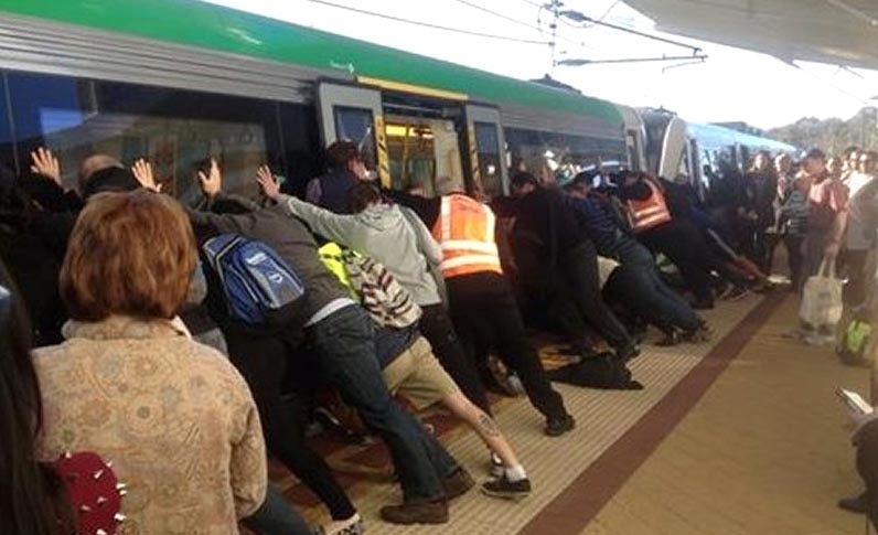 Train rescue: Commuters use people power to free man trapped against ...