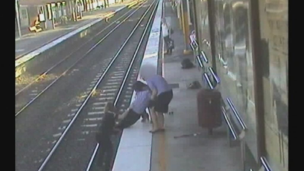 Woman rescues man who fell onto train tracks - ABC News