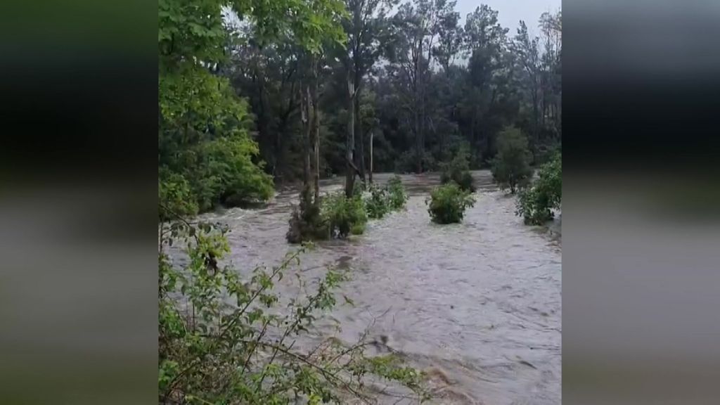 Previously dry Queensland riverbed raging after significant rainfall ...