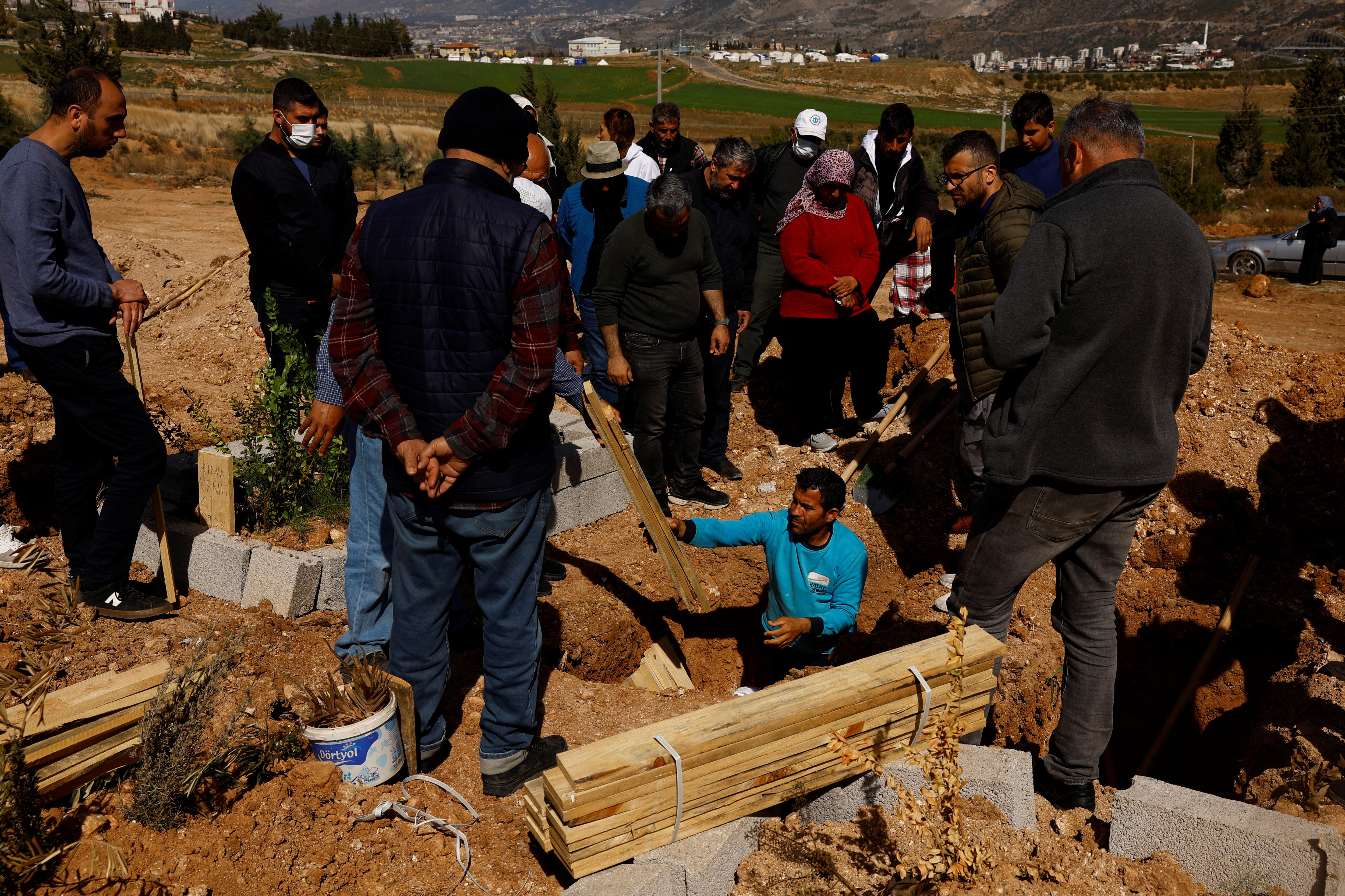 Turkish undertaker moves family to cemetery as he buries victims of ...