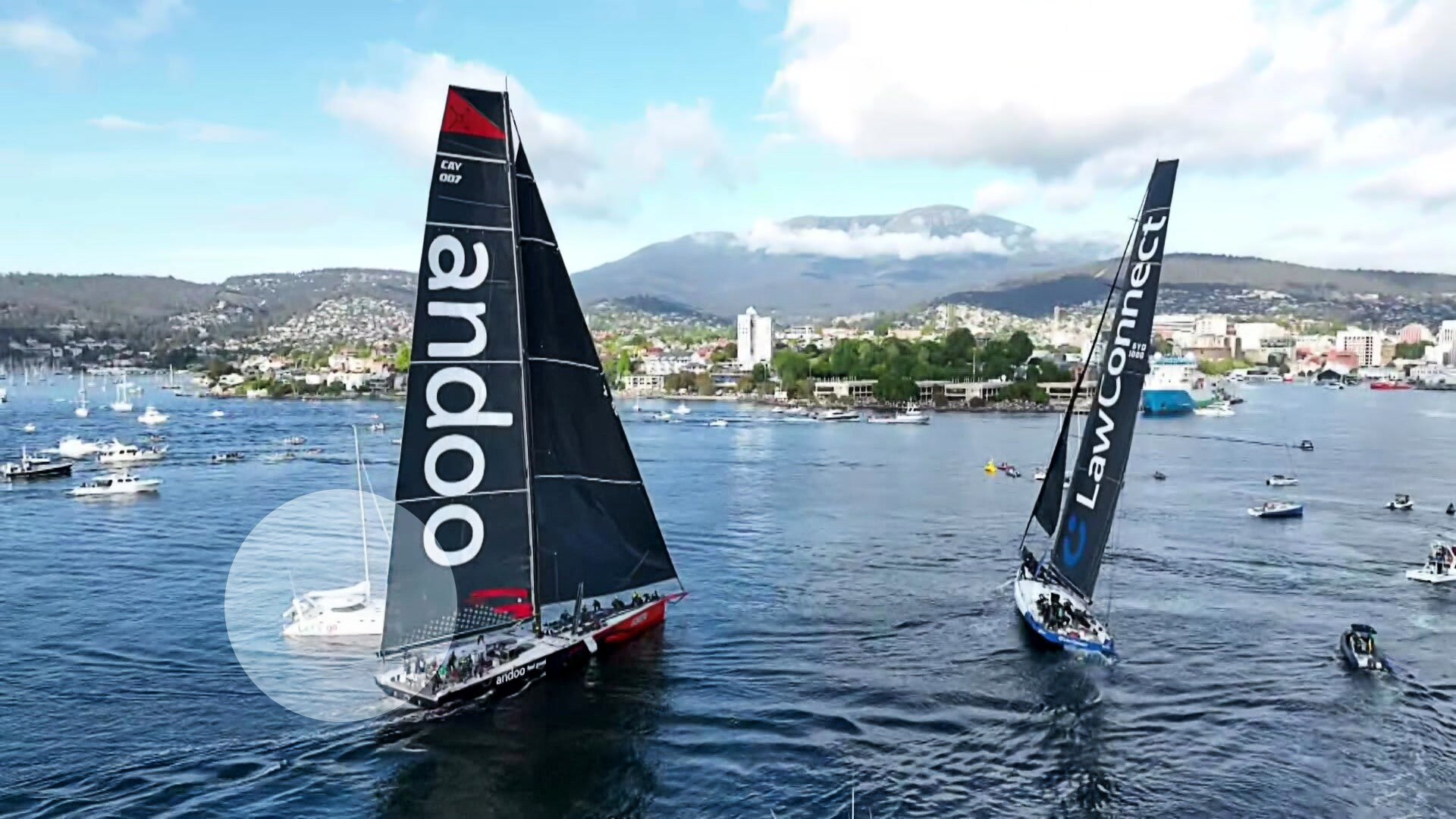 A catamaran crosses in front of Andoo Comanche in the final moments of ...