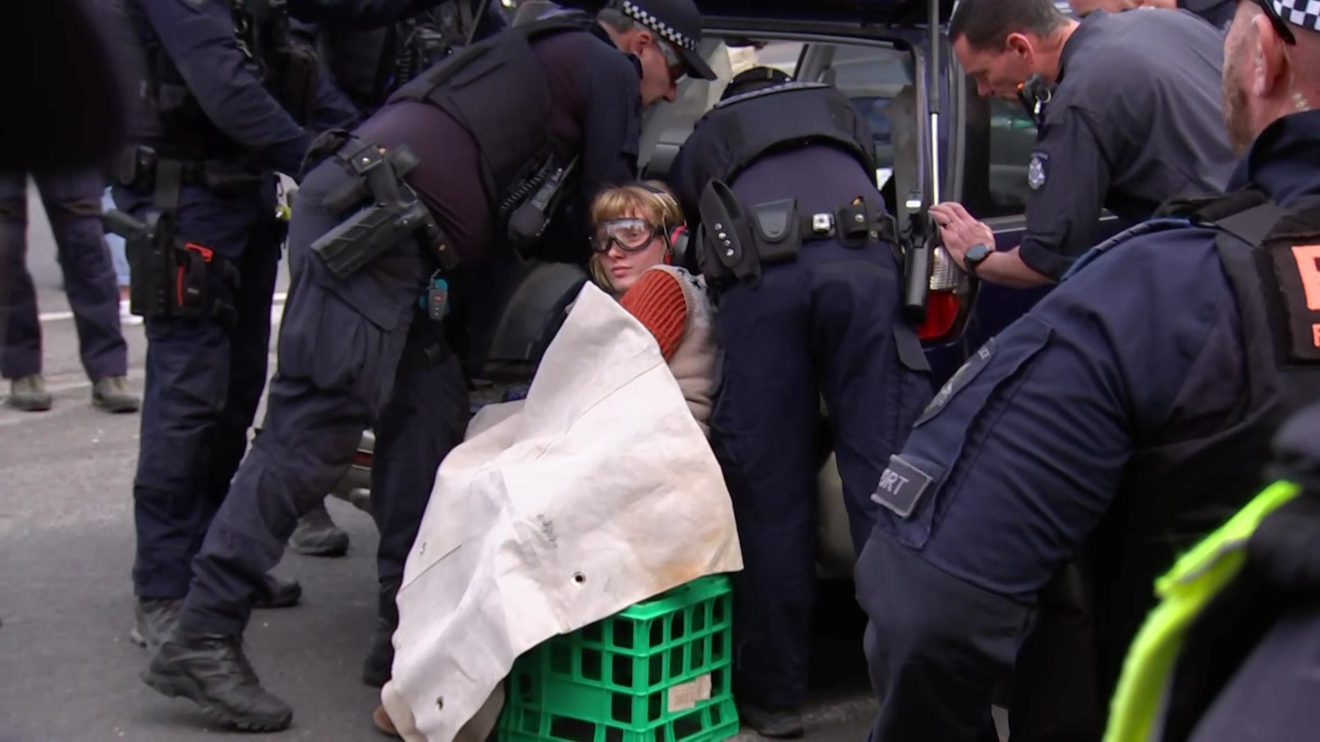 Victorian premier defends Land Forces expo as police charge woman on ...