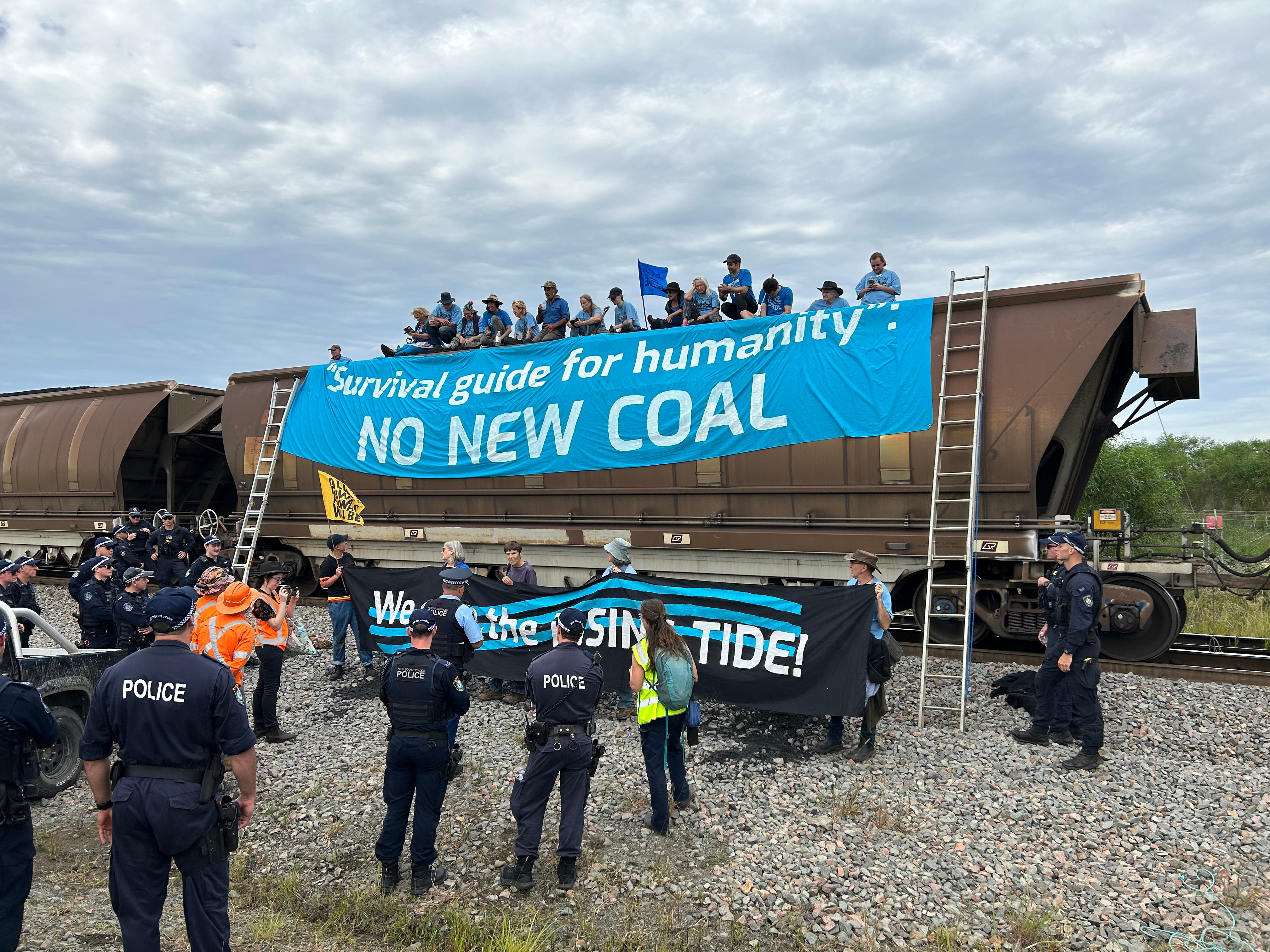 Anti-coal mine protesters stop coal train in Newcastle, dozens arrested ...