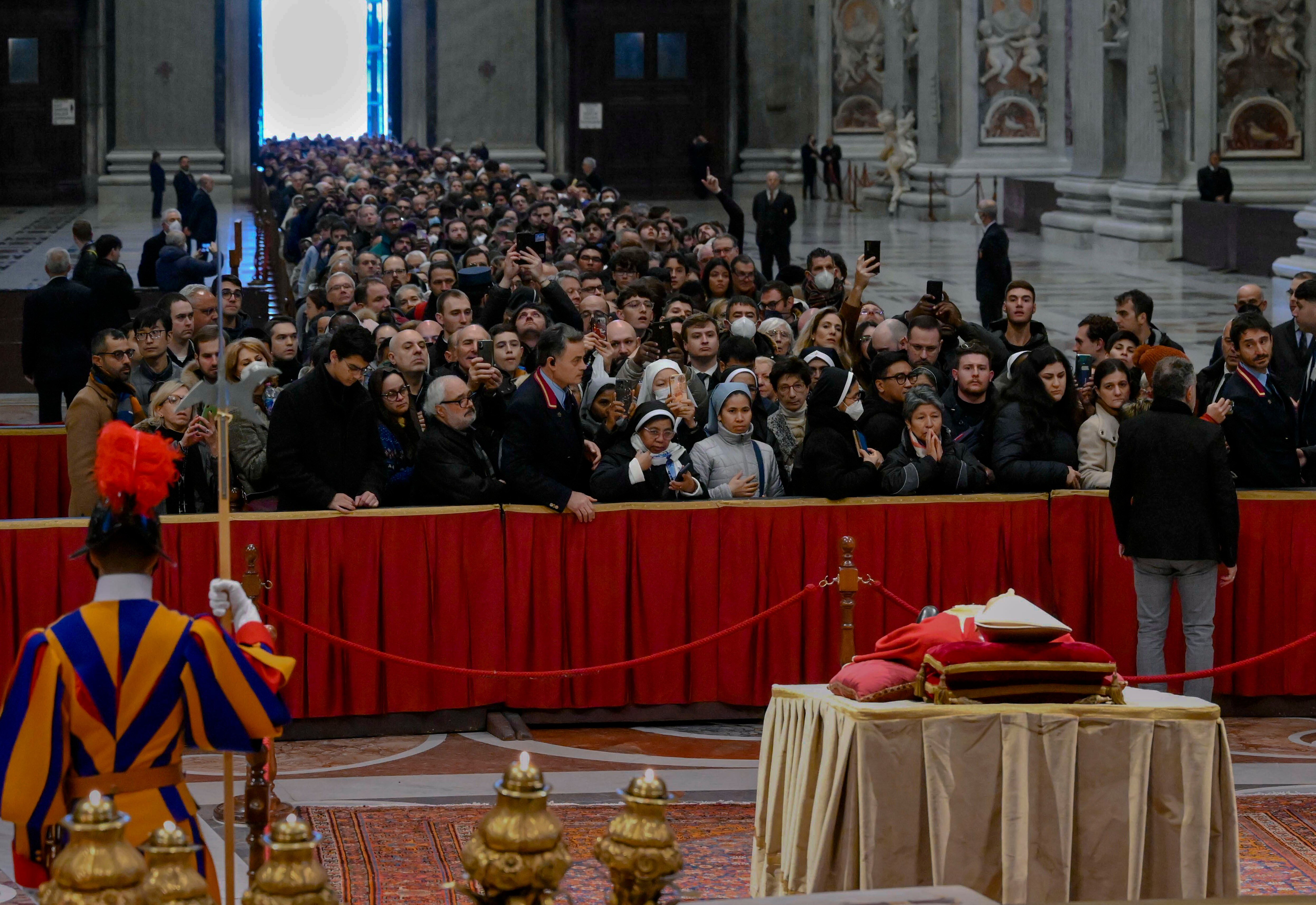 Thousands file into St Peter's Basilica to view body of former pope ...