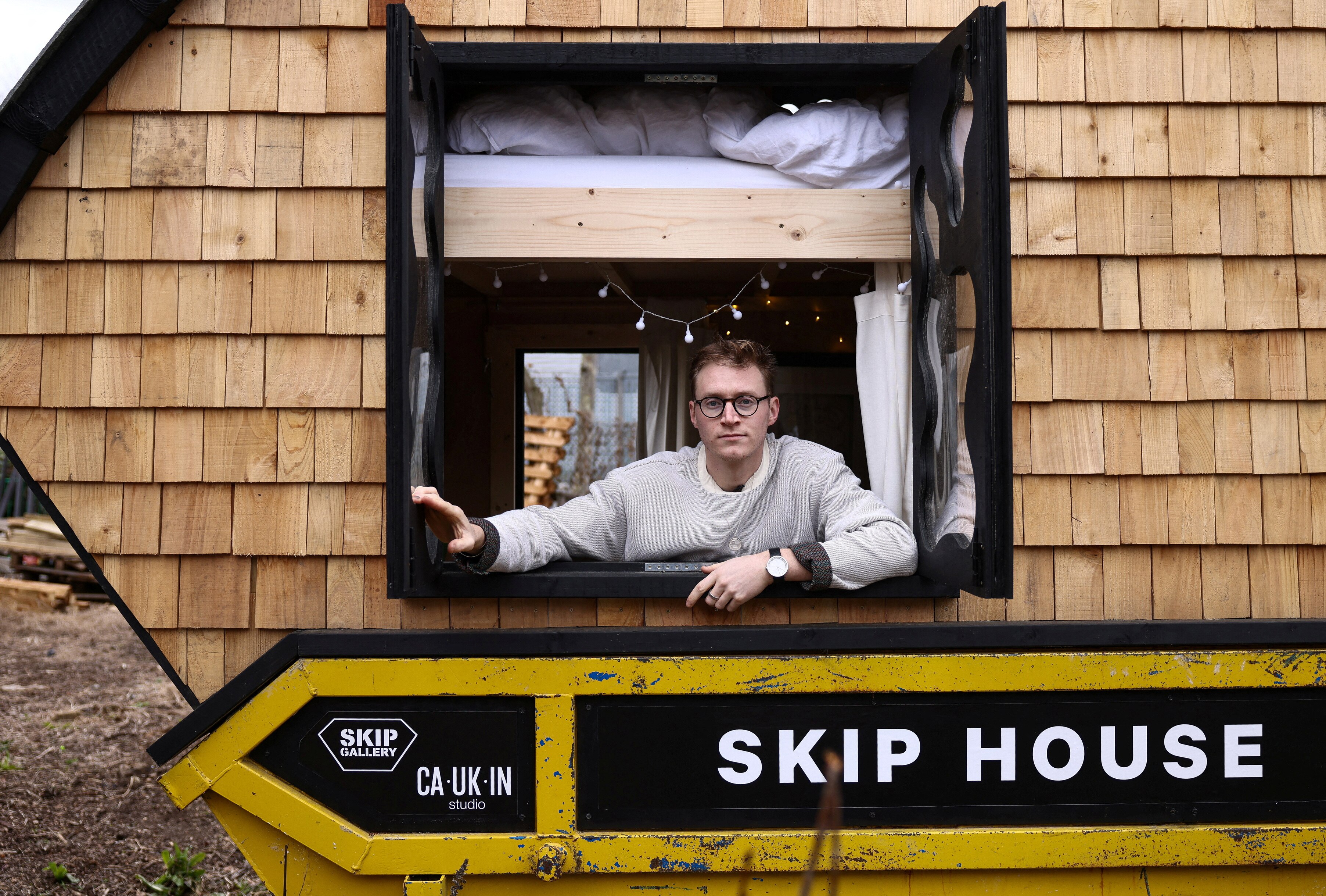 Artist builds home in a rubbish skip to protest against soaring rental ...