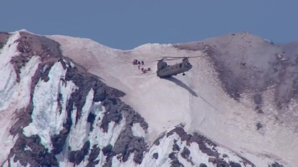 Footage shows helicopter reversing into mountainside in daring rescue ...