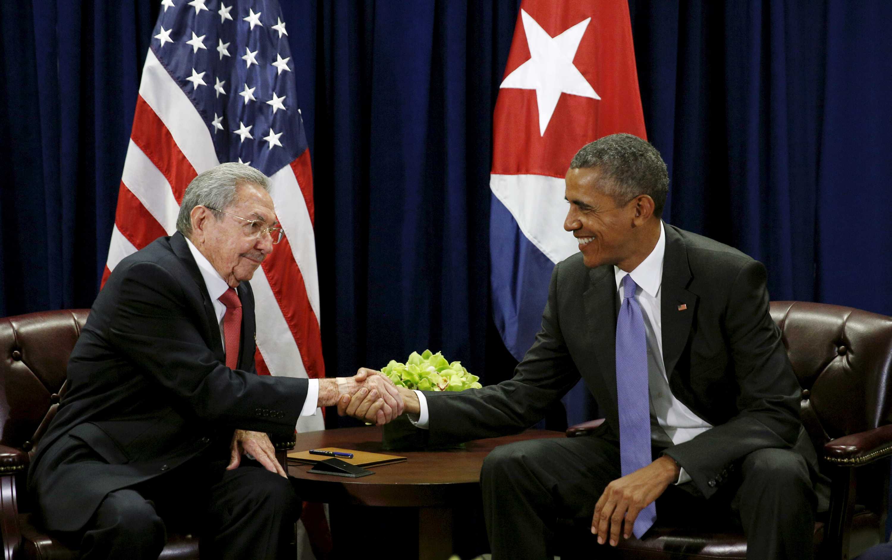 Barack Obama shakes hands with Cuban president Raul Castro as two ...