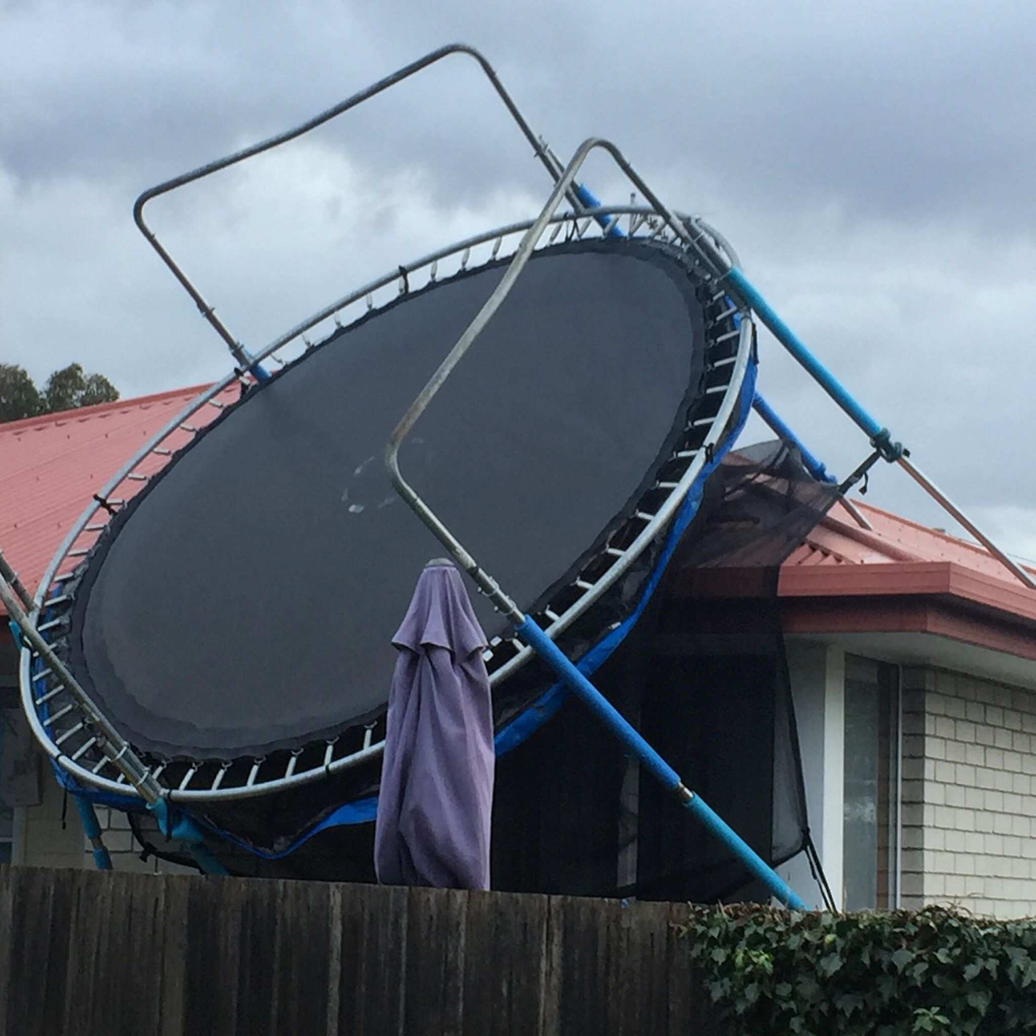 Trampoline tossed through roof as winds leave trail of damage in ...